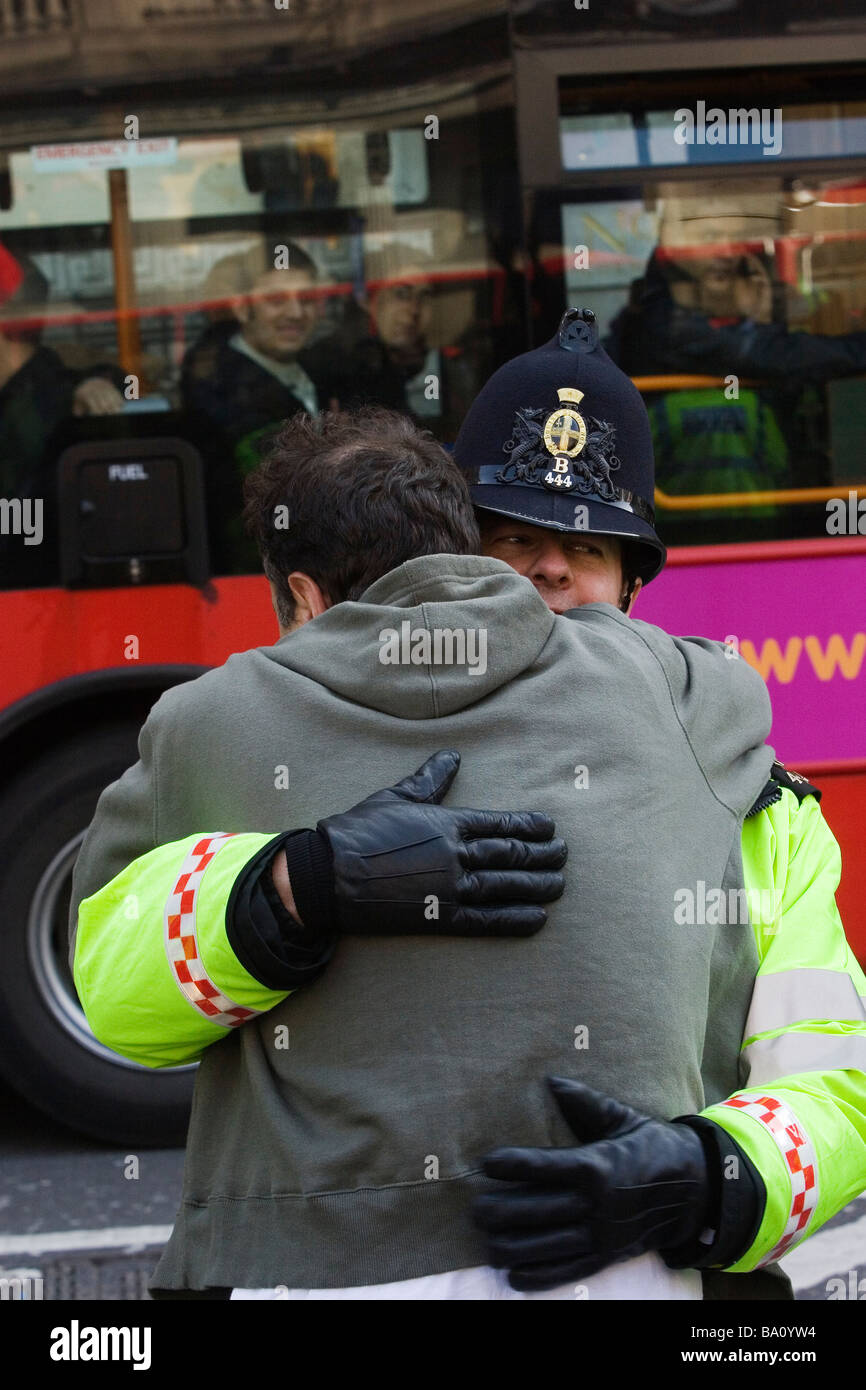 City of London police officer hugging a protester Stock Photo - Alamy
