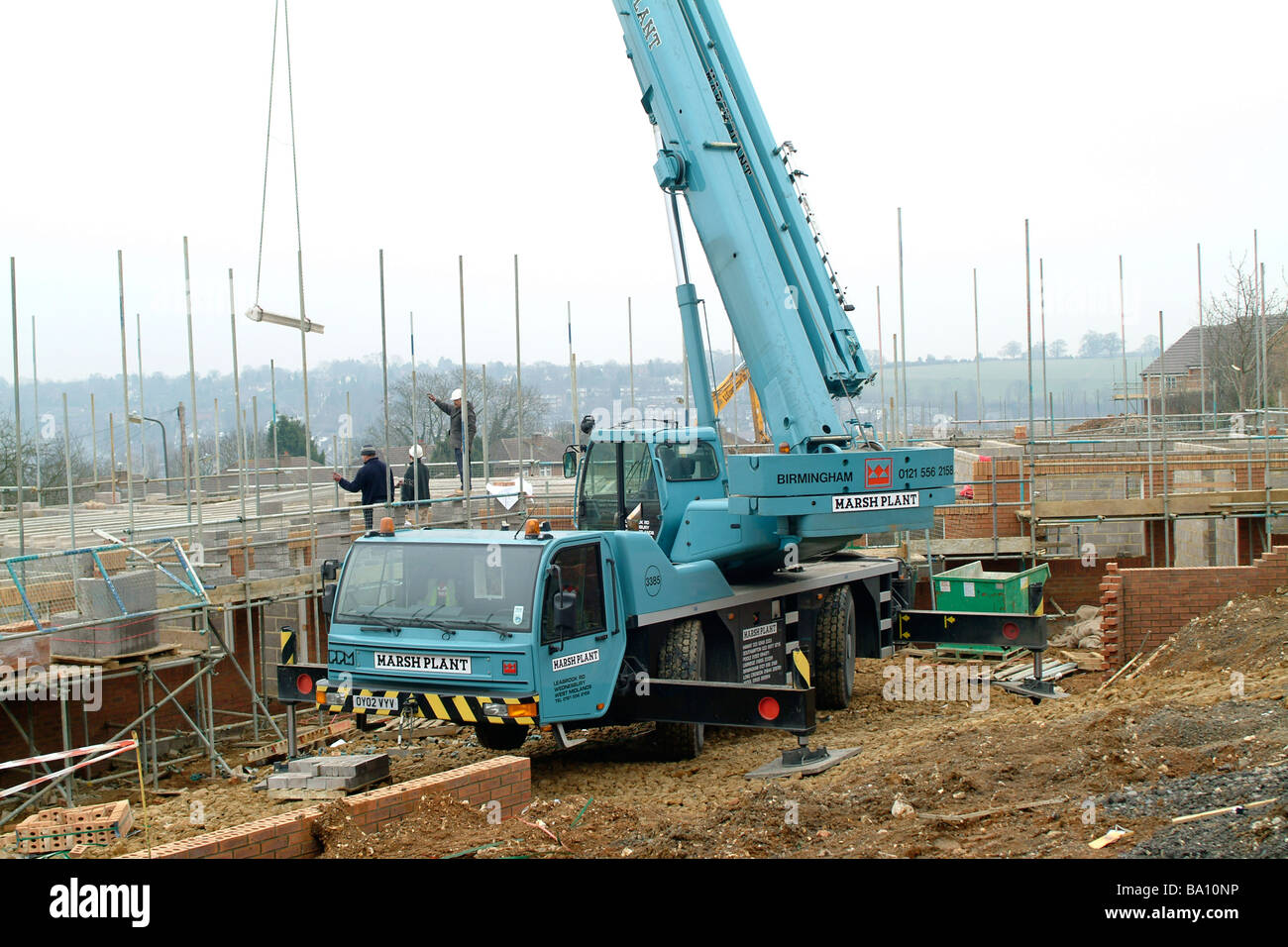 Mobile crane working on a busy building site in England Stock Photo - Alamy