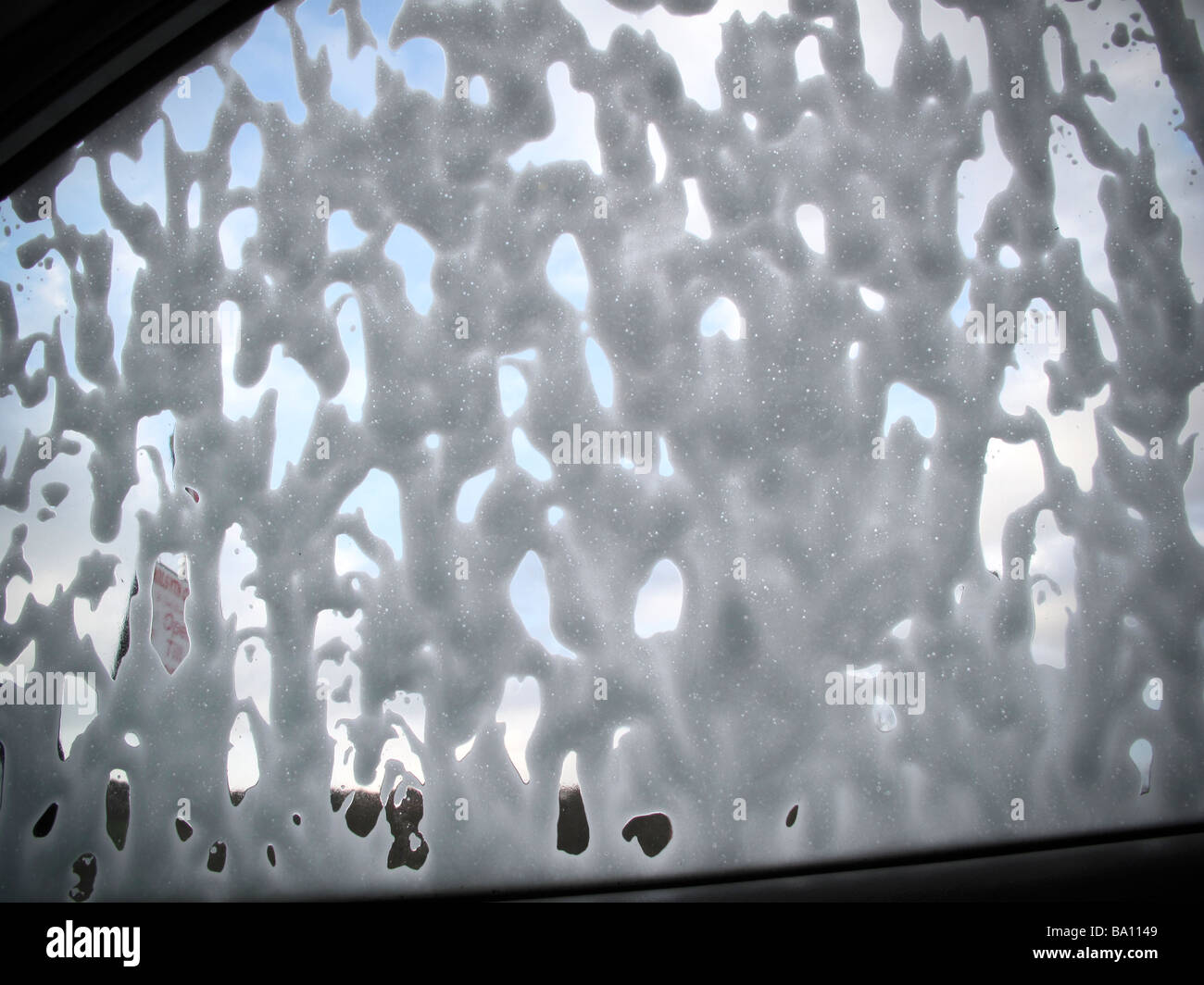Soap suds on window of car being washed Stock Photo - Alamy