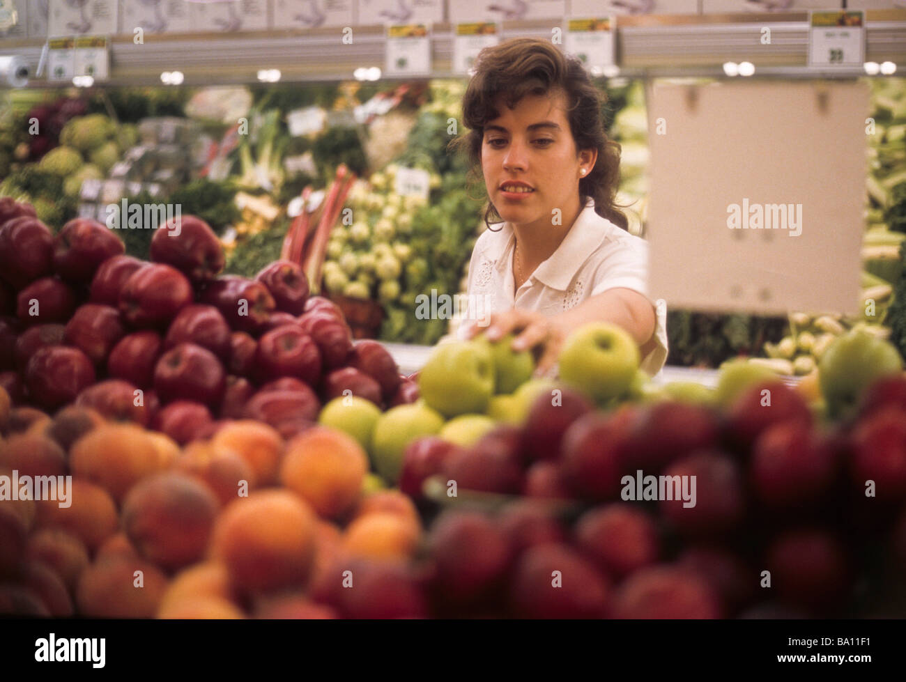 Hispanic woman choose select pick apple fruit store grocery market food ...
