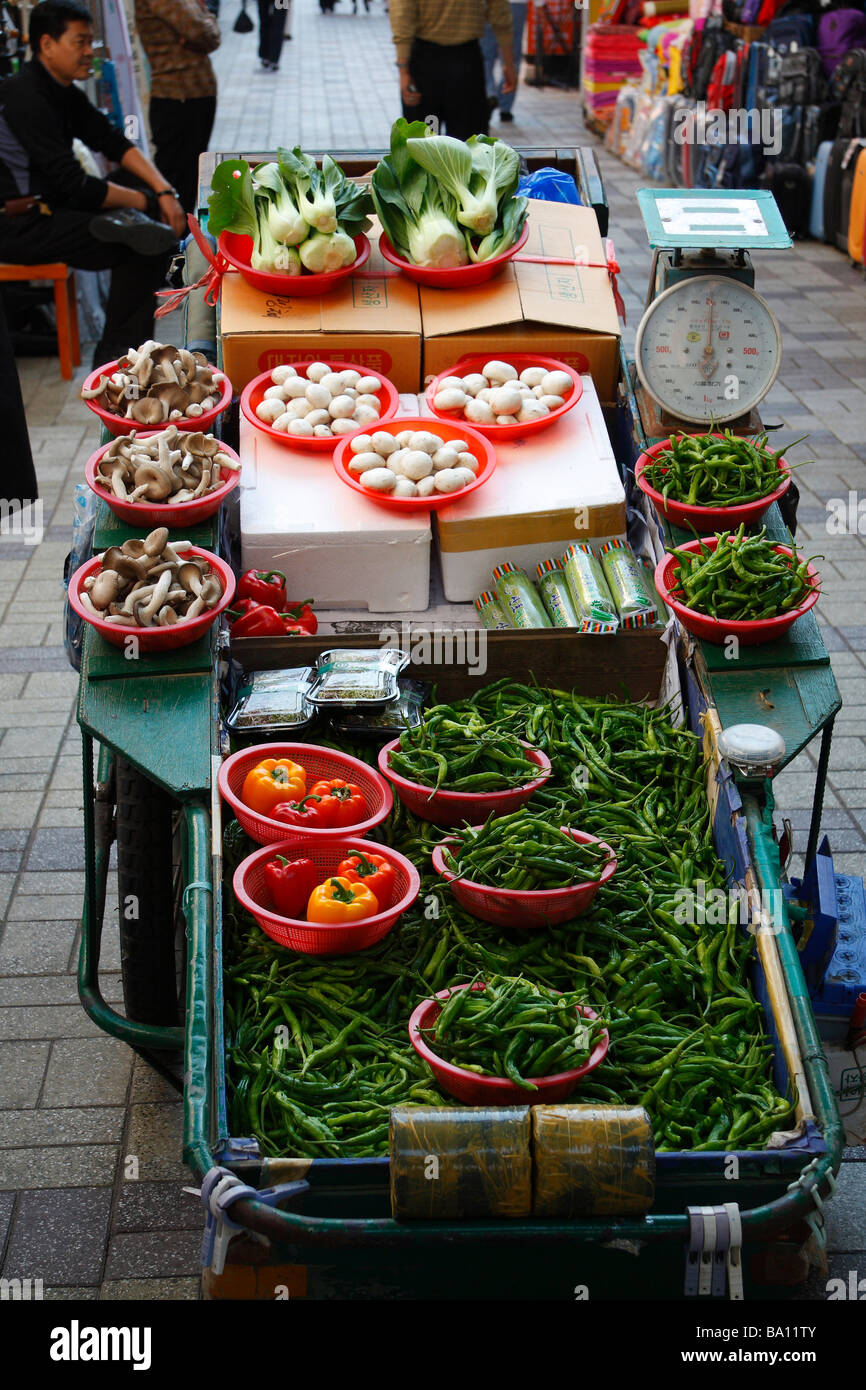 A merchant displaying his fresh produce for sale on a big cart on the ...