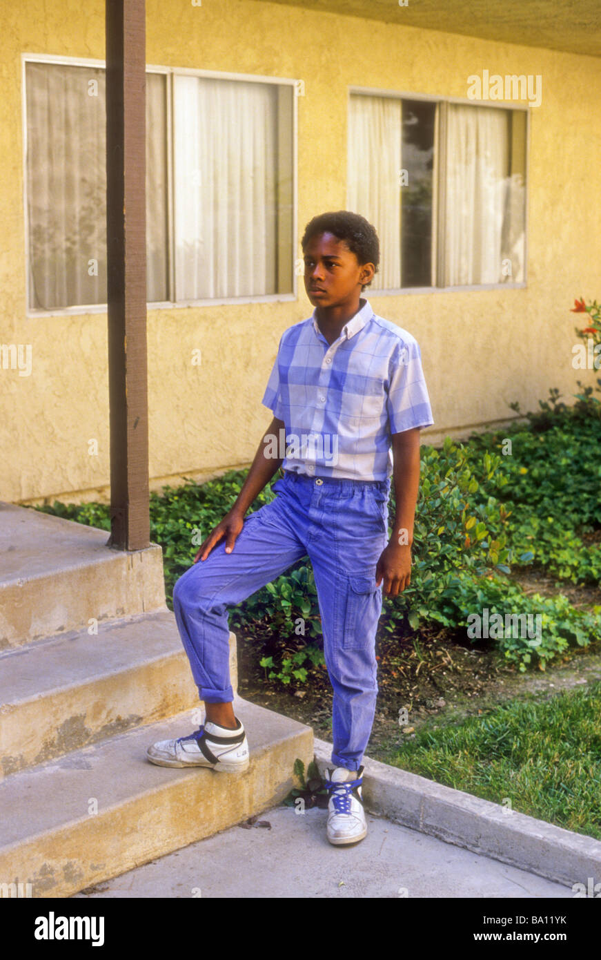 Black teen boy seriious intent direct look stare face sun portrait ...