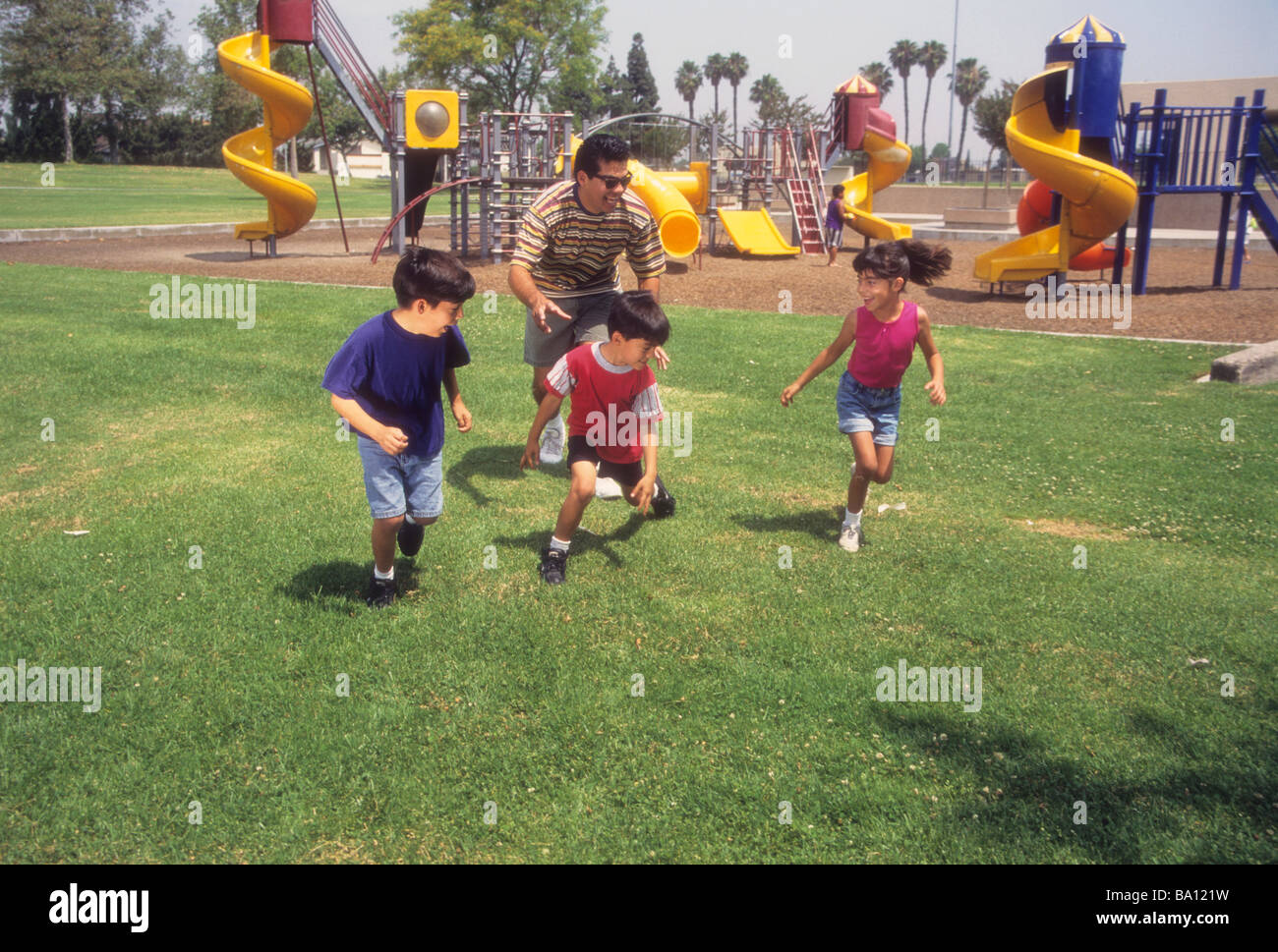 Dad father play kid child run chase tag laugh fun happy tease tickle ...