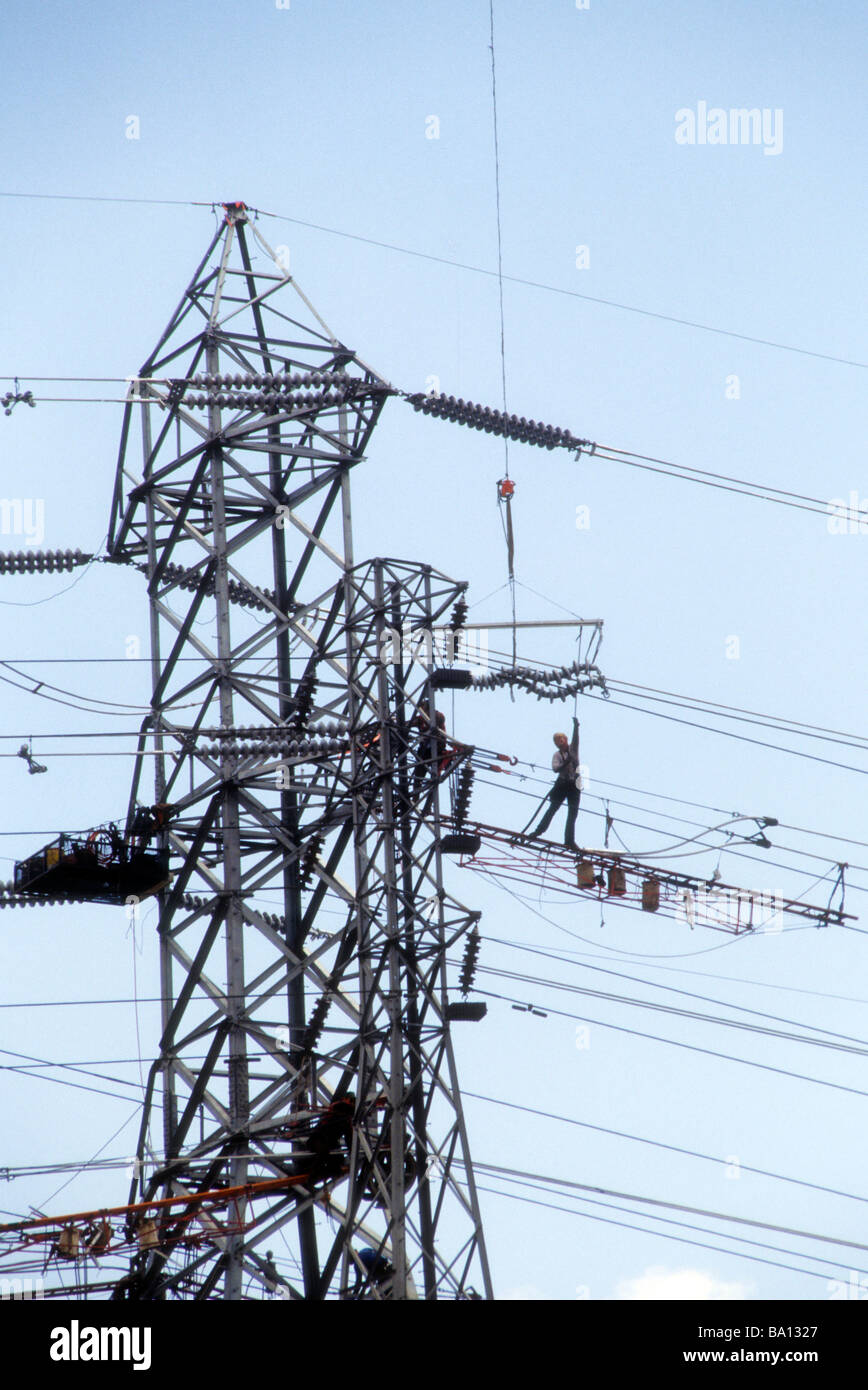 man worker dwarf huge high tall electric power tower wire cable tension ...