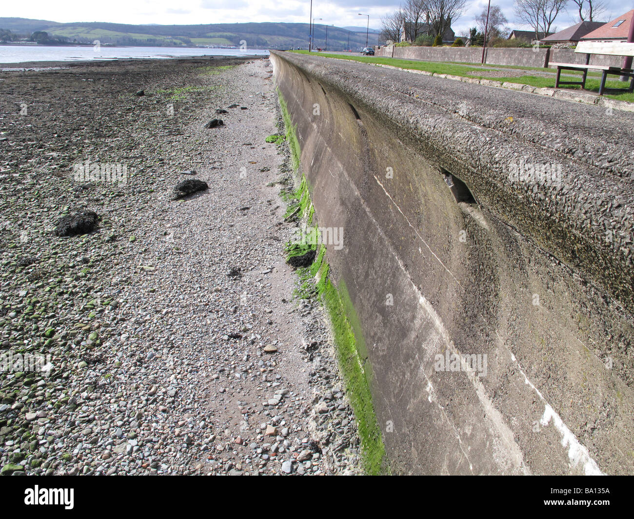 Sea wall along stoney beach front Stock Photo - Alamy