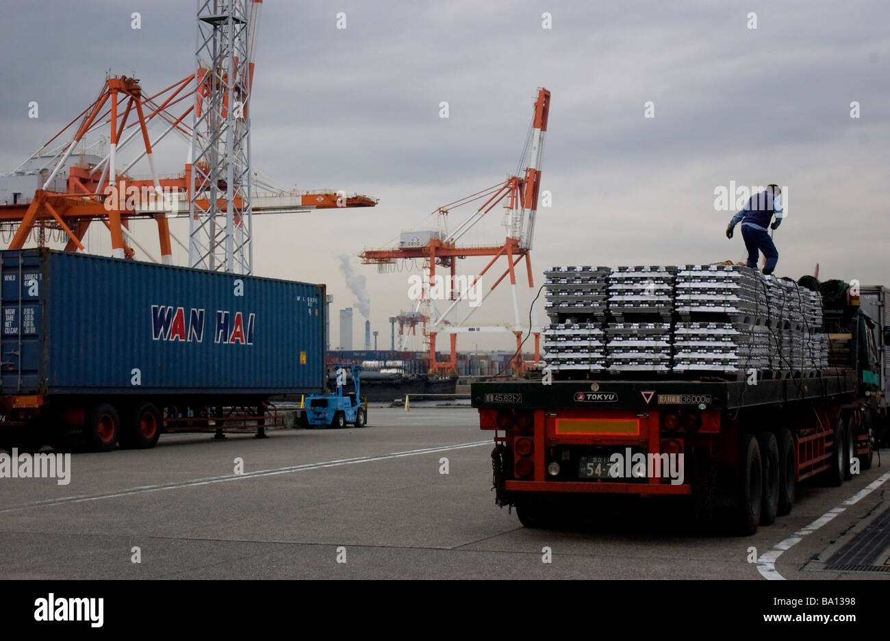 A truck driver checks his load at the port of Yokohama outside Tokyo ...