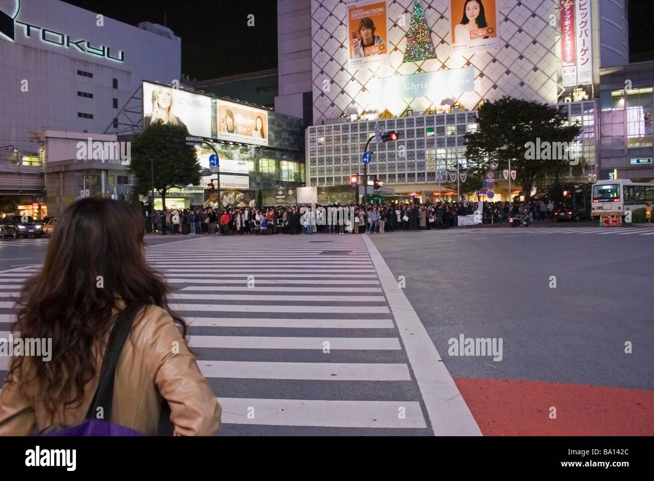 A Japanese Woman Is Waiting For The Green Light In Order To Cross The ...