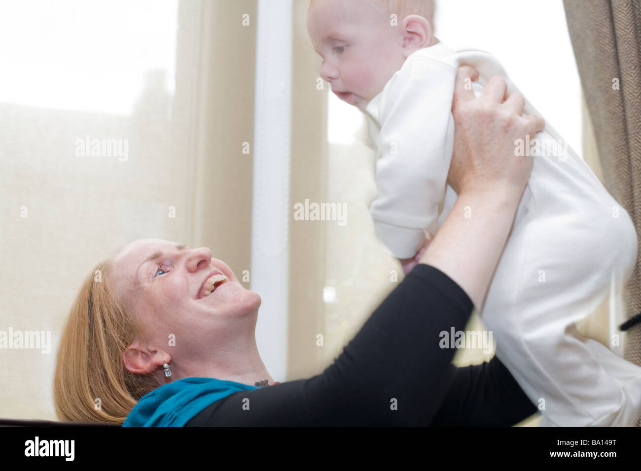 Baby held aloft hi-res stock photography and images - Alamy
