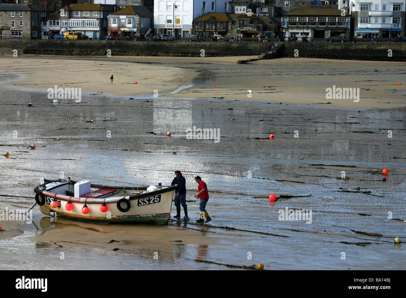 Fishermen attending to craft St. Ives harbour beach Cornwall UK Stock ...