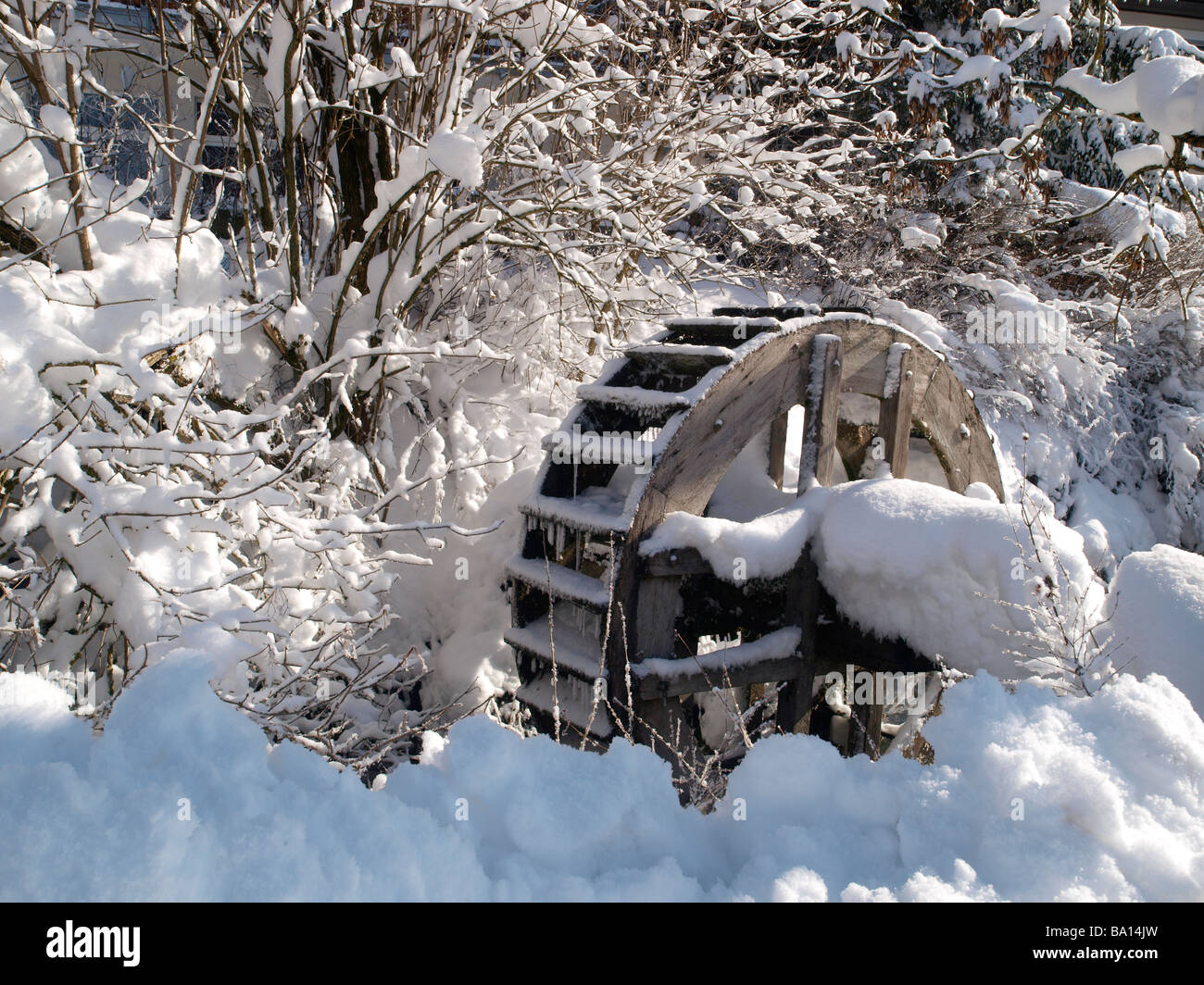 Winter scene of Old water wheel covered with snow Stock Photo - Alamy