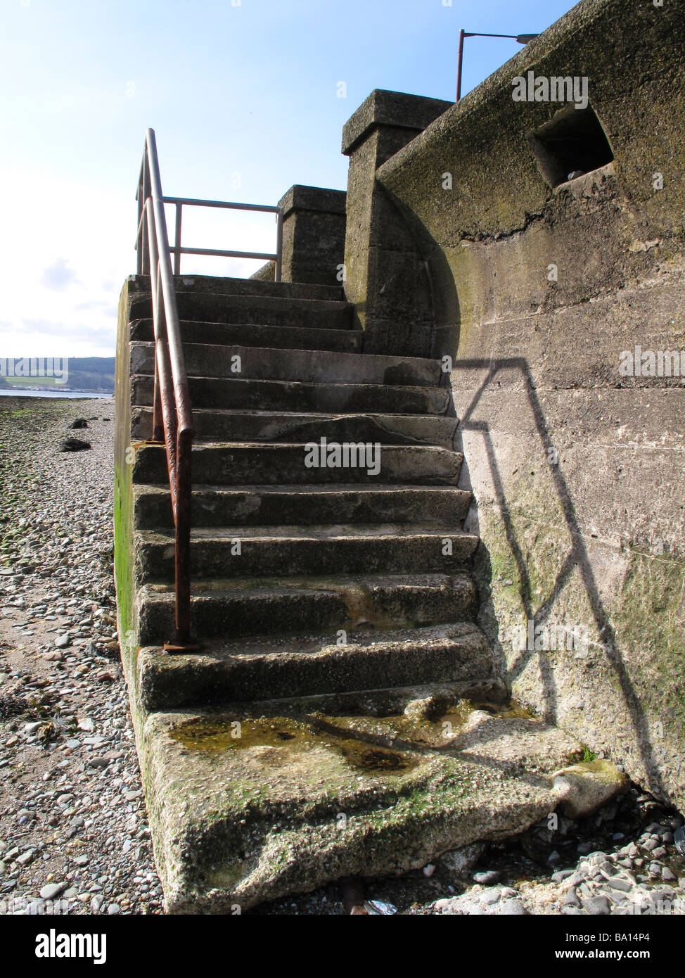 Worn stairs onto stony beach Stock Photo - Alamy