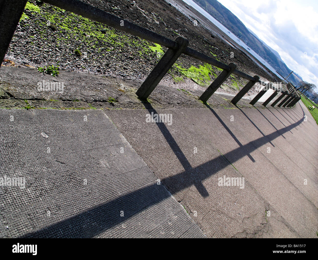 railing and high contrast shadows on path Stock Photo - Alamy