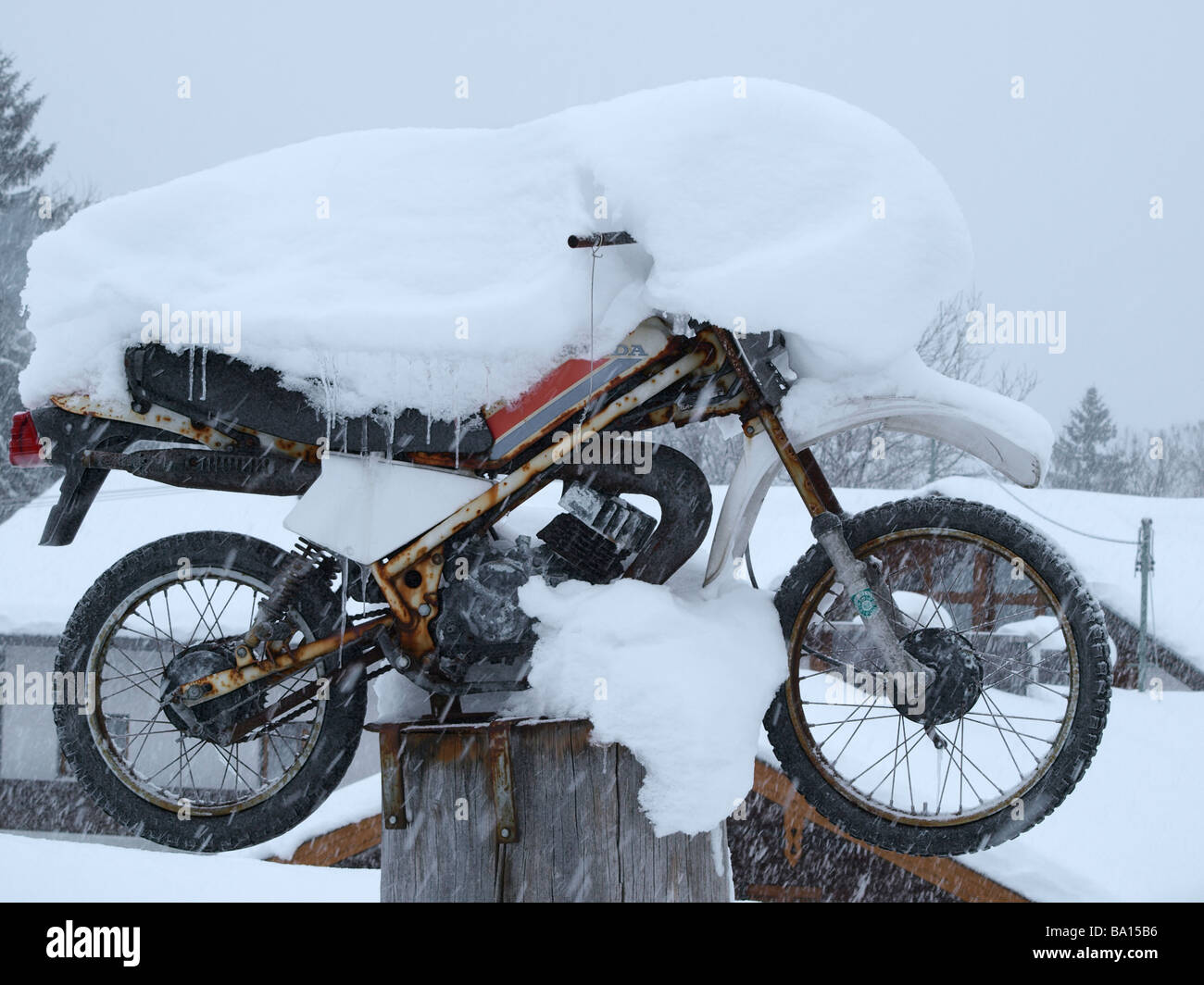 Old rusty motorcycle covered with snow Stock Photo - Alamy