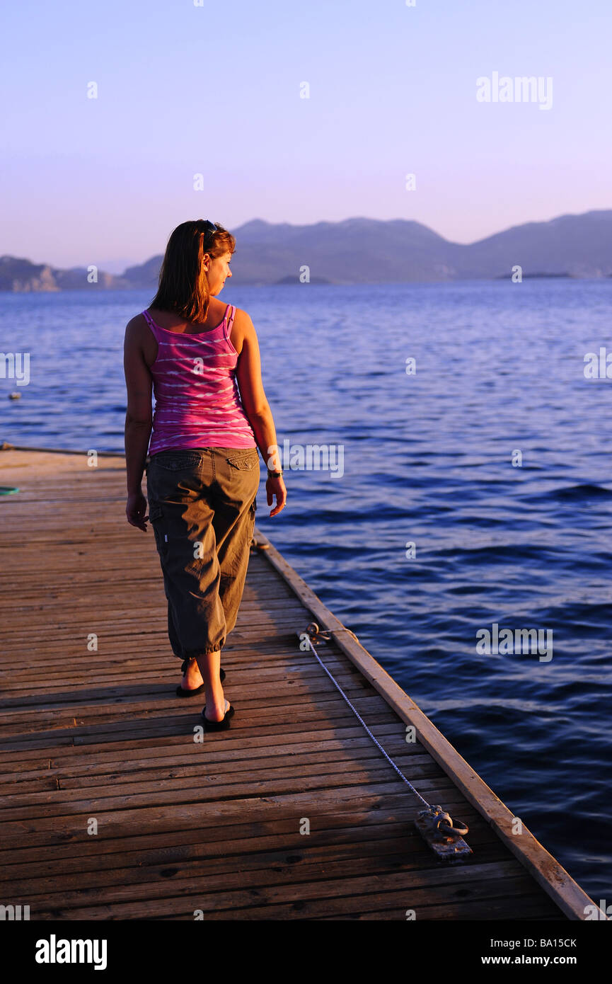Woman walking on jetty alone hi-res stock photography and images - Alamy