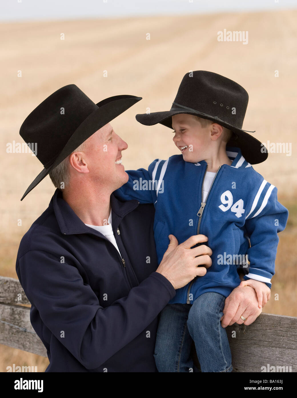 Father and son wearing cowboy hats Stock Photo - Alamy