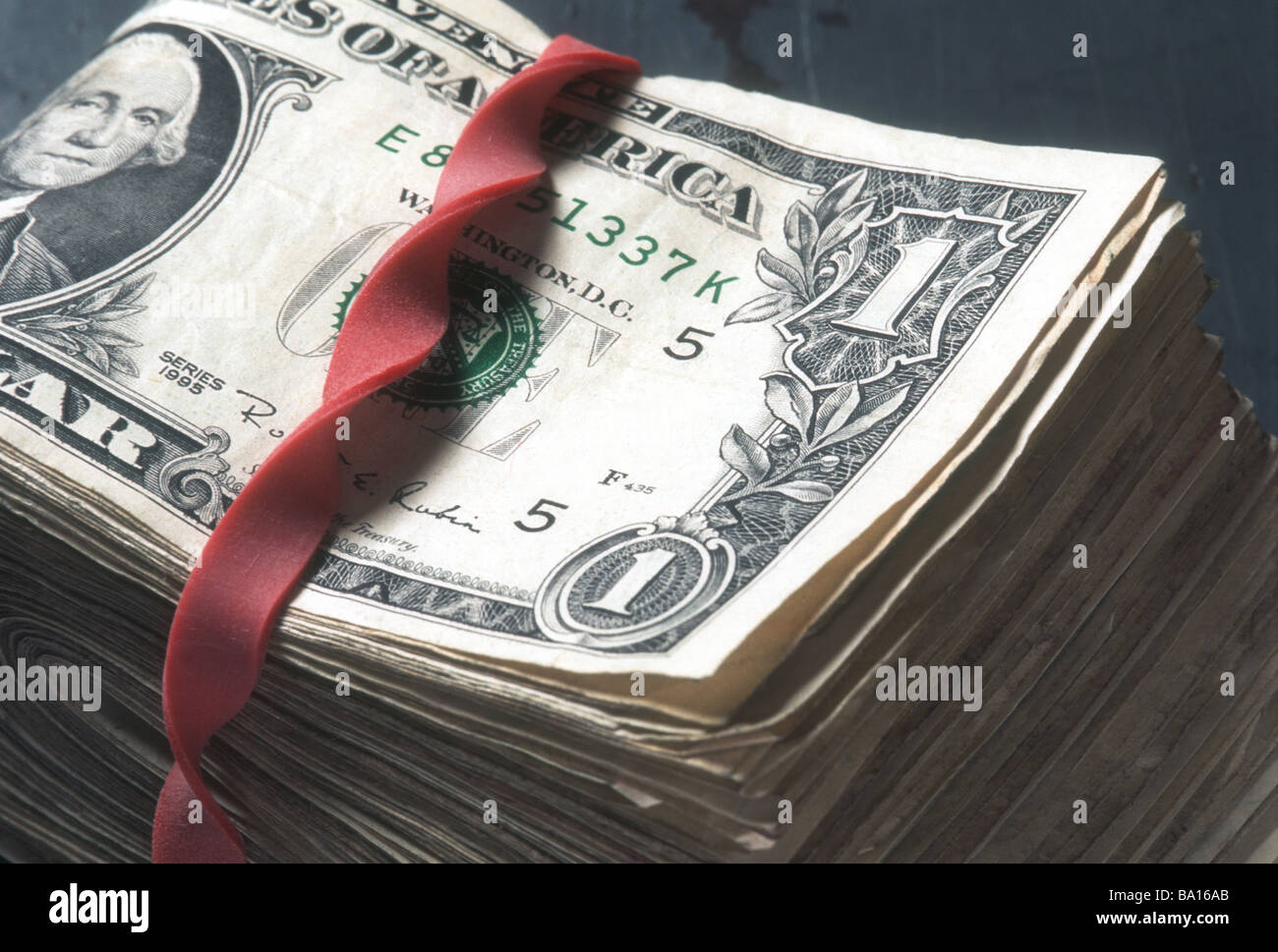 stack of US dollars wrapped with rubber band Stock Photo - Alamy
