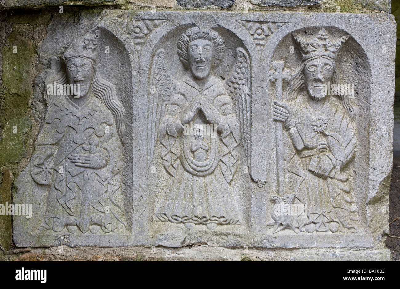 Relief carving of 3 figures. A carved relief on the side of a coffin in ...