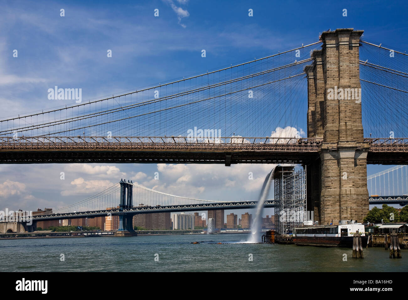 A view of the Brooklyn and Manhattan Bridges on the East River with the ...