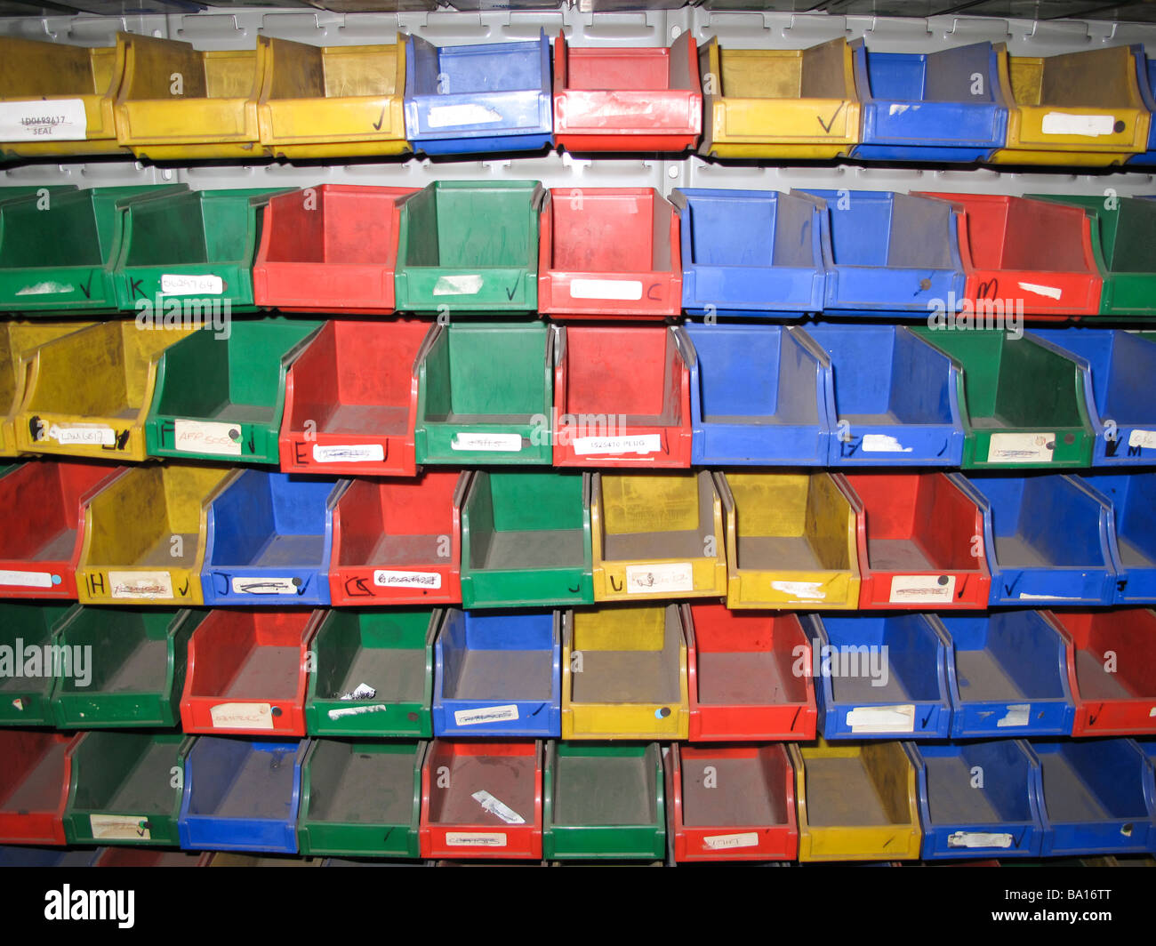 Plastic parts storage bins on wall racking Stock Photo - Alamy