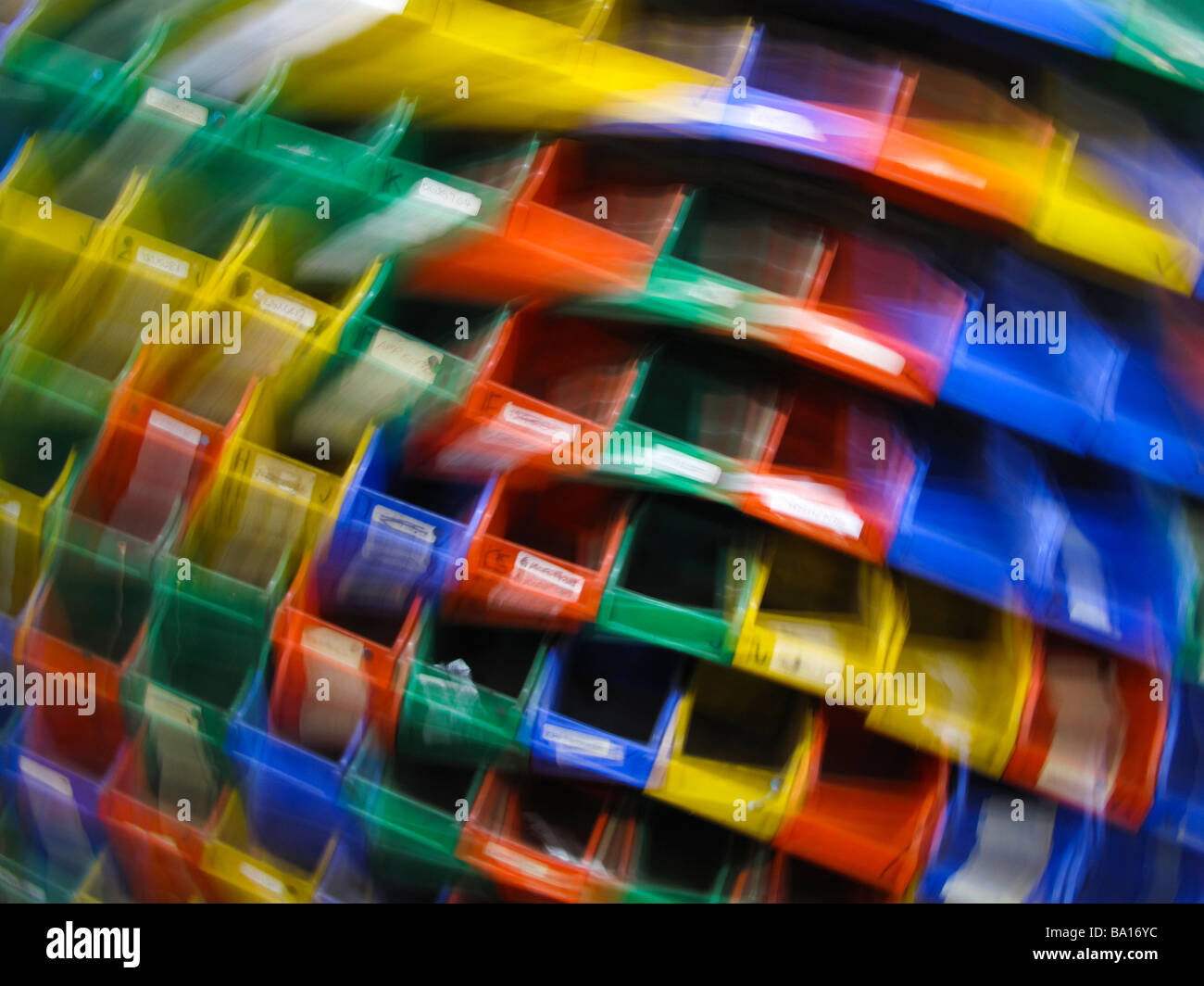 Plastic parts storage bins on wall racking Stock Photo - Alamy