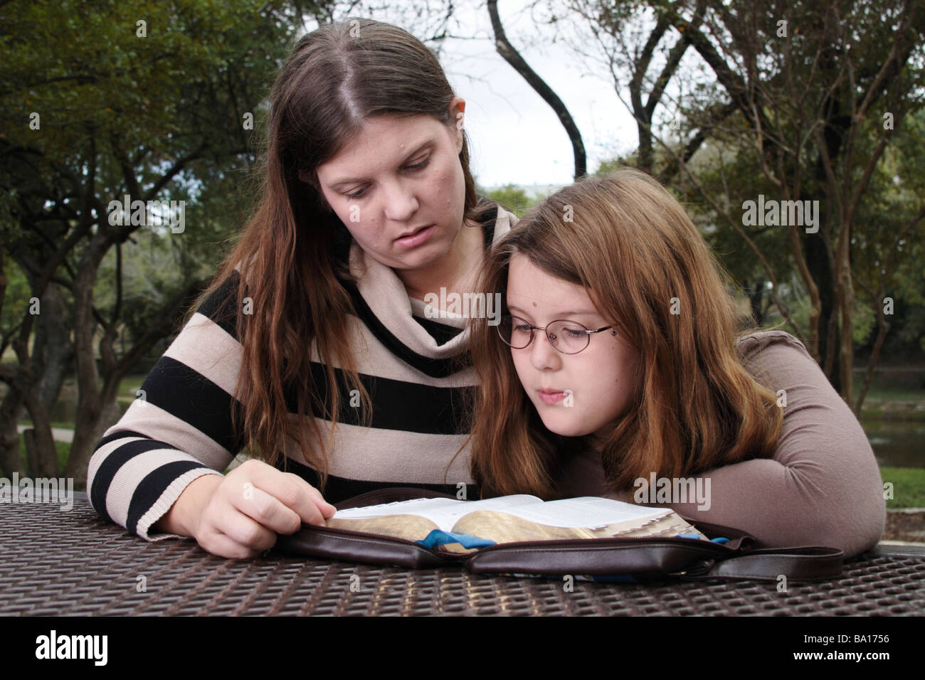Mother and daughter reading the bible together Stock Photo - Alamy