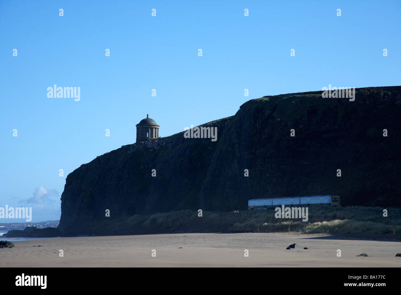 train passing Benone beach and Mussenden Temple on clifftop downhill ...
