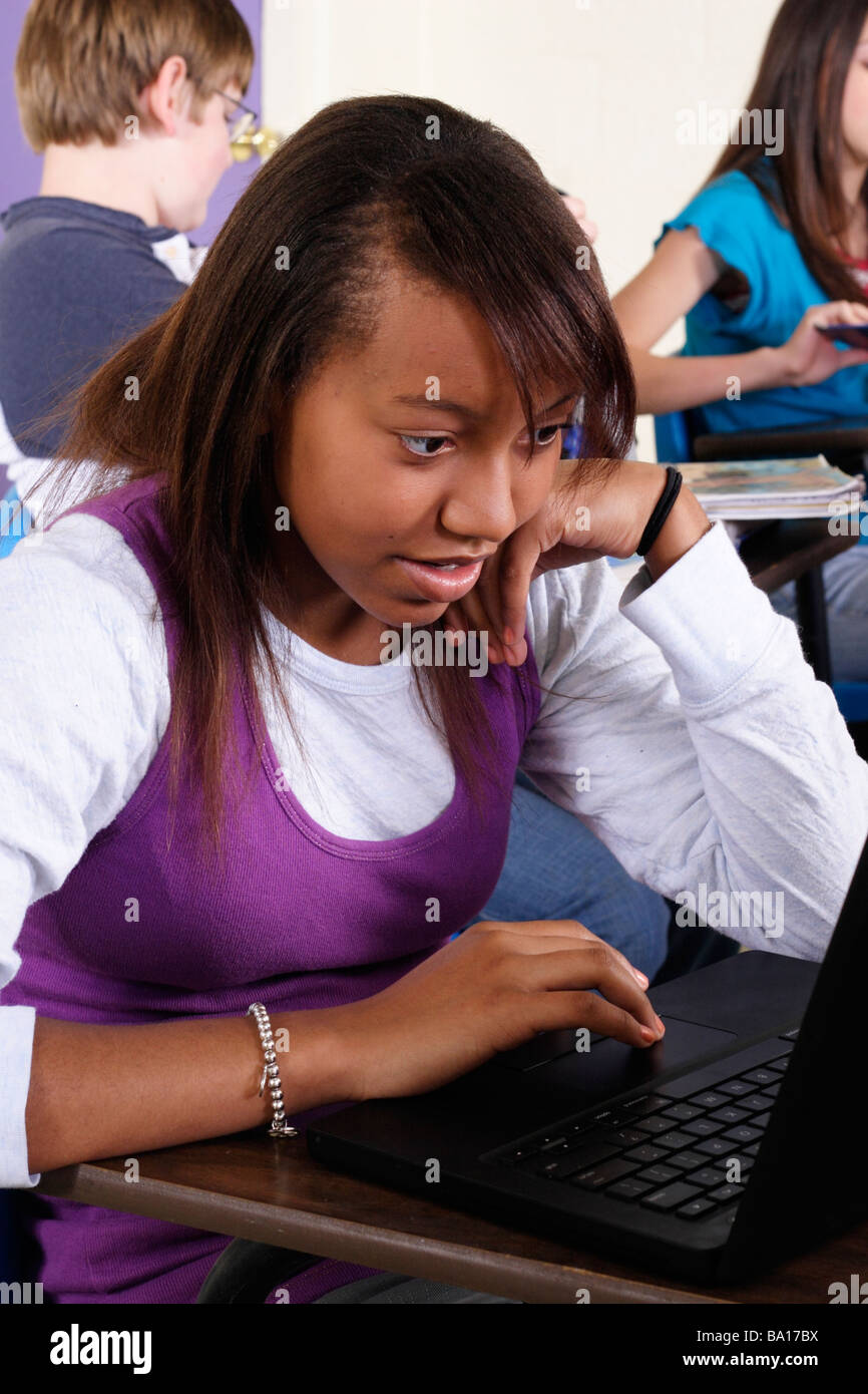 Student using notebook computer in class Stock Photo - Alamy