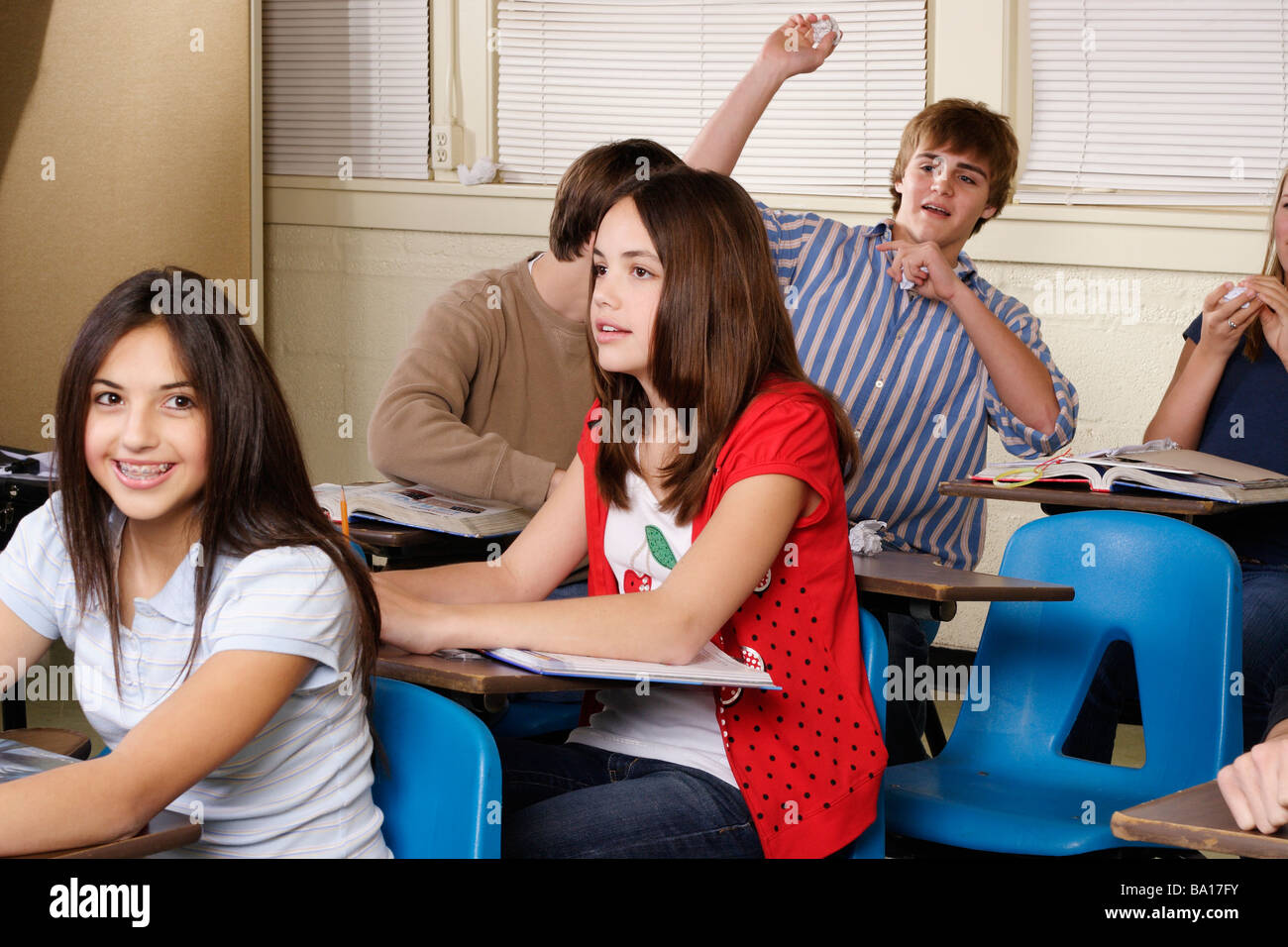 Male student about to throw a paper wad in class Stock Photo - Alamy