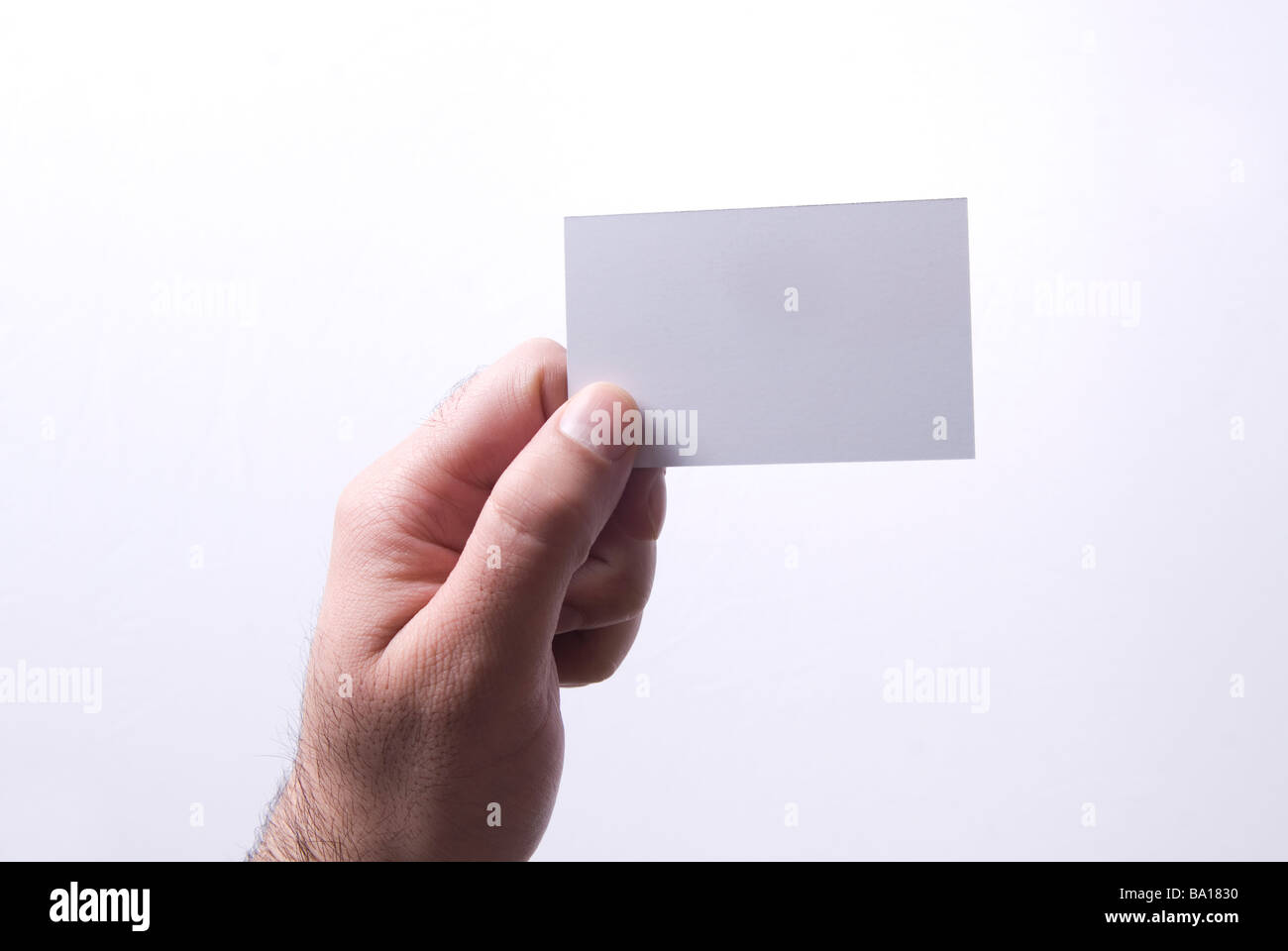 Hand holding a white card sign against a white background Stock Photo ...