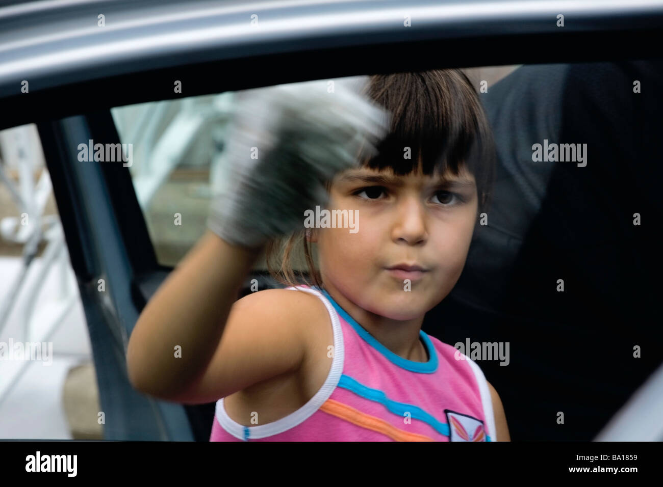 Girl cleaning car window Stock Photo - Alamy