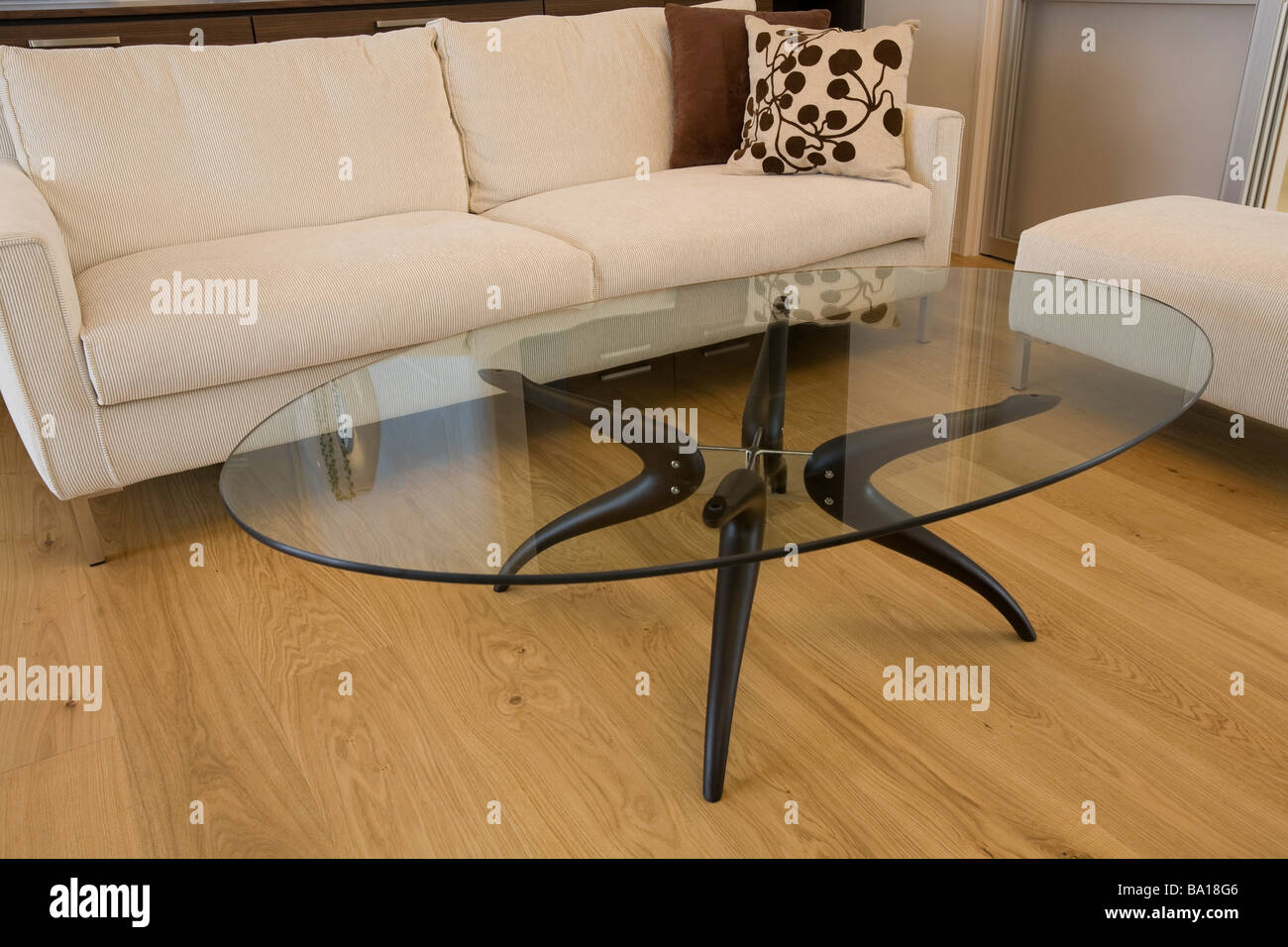 Sofa and glass table Stock Photo - Alamy