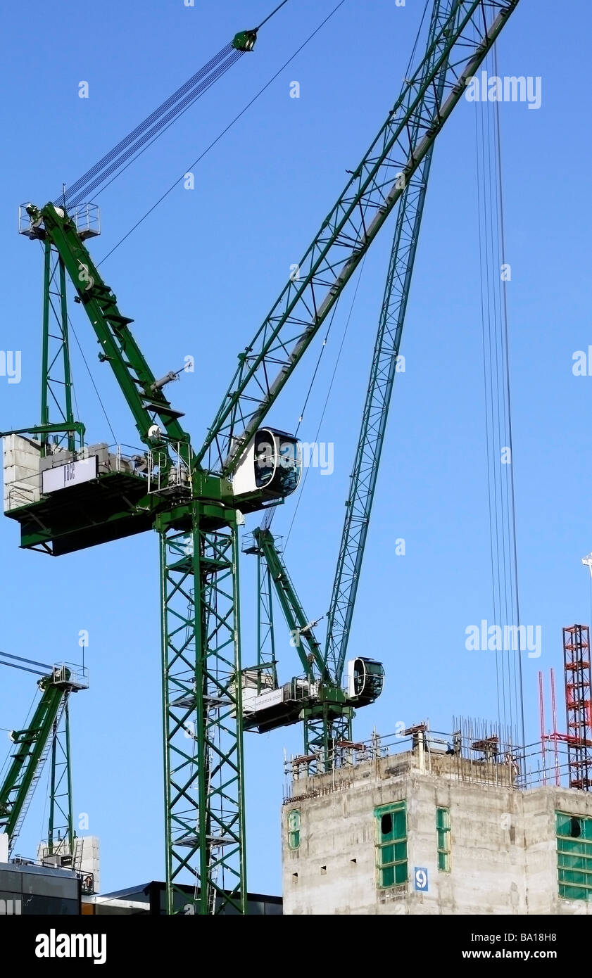 Digital still camera. Two cranes, a building being built, blue sky ...