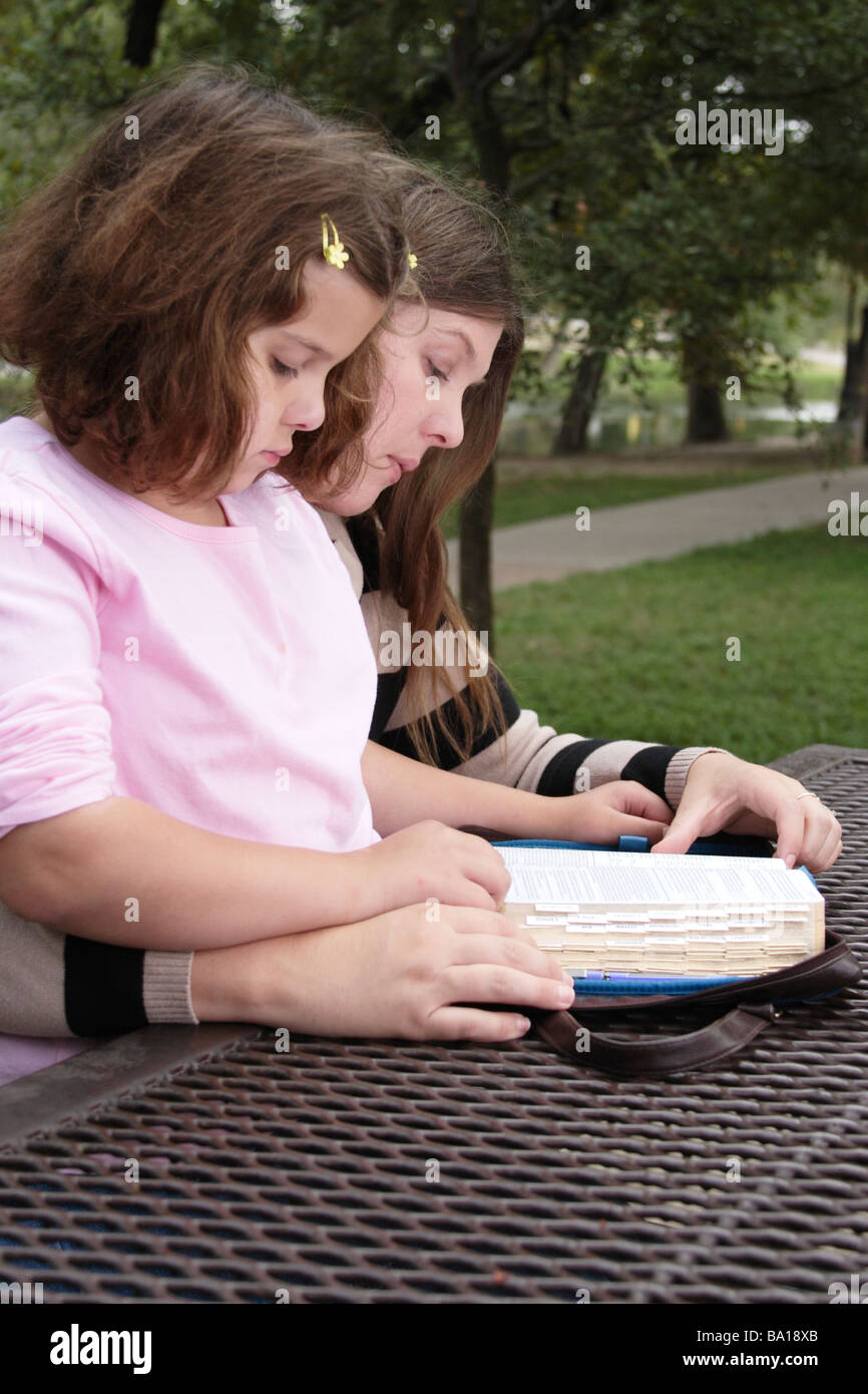 Mother and daughter reading the bible together Stock Photo - Alamy