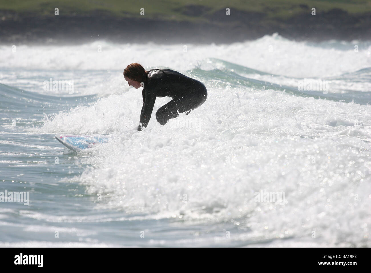 Surfer begins to stand Stock Photo - Alamy