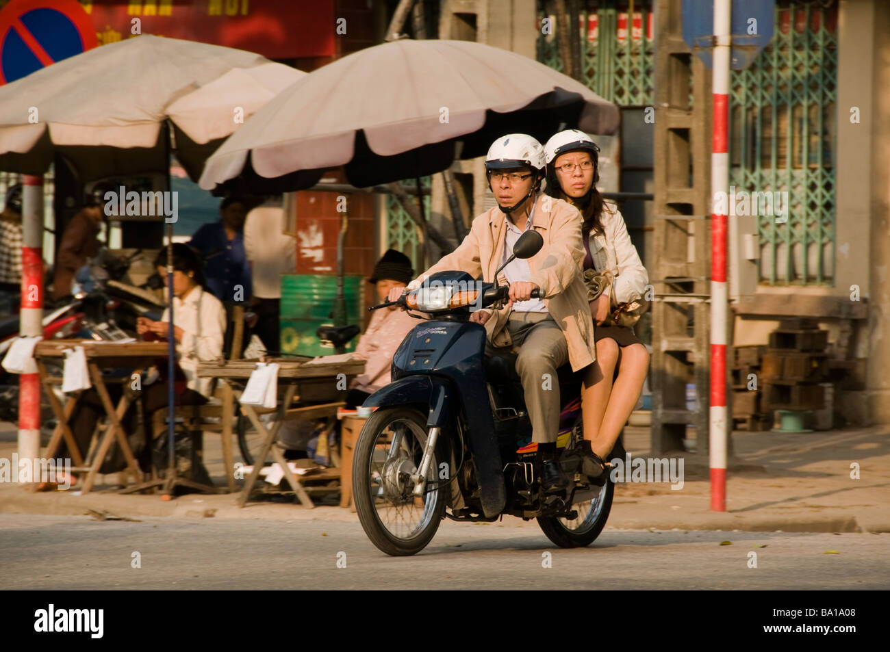 couple commuting on a motorcycle in Hanoi Vietnam Stock Photo - Alamy
