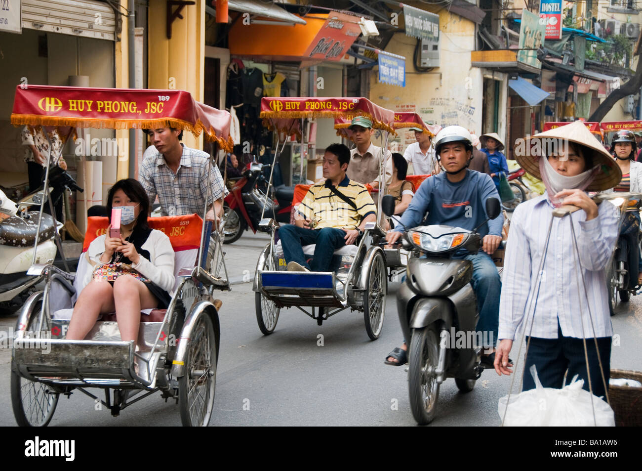 cyclos riding the streets in Hanoi Vietnam Stock Photo - Alamy