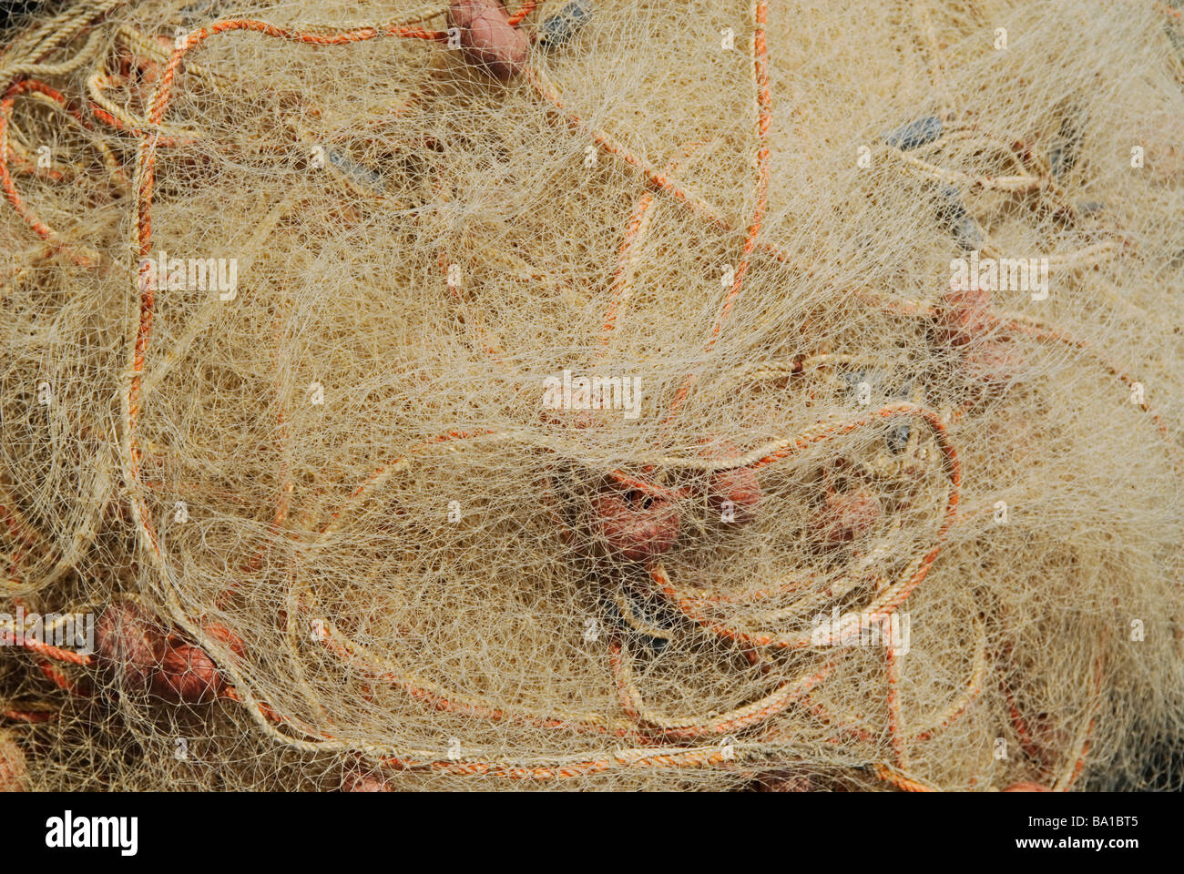 Close up of a fishing net piled outdoors Stock Photo - Alamy