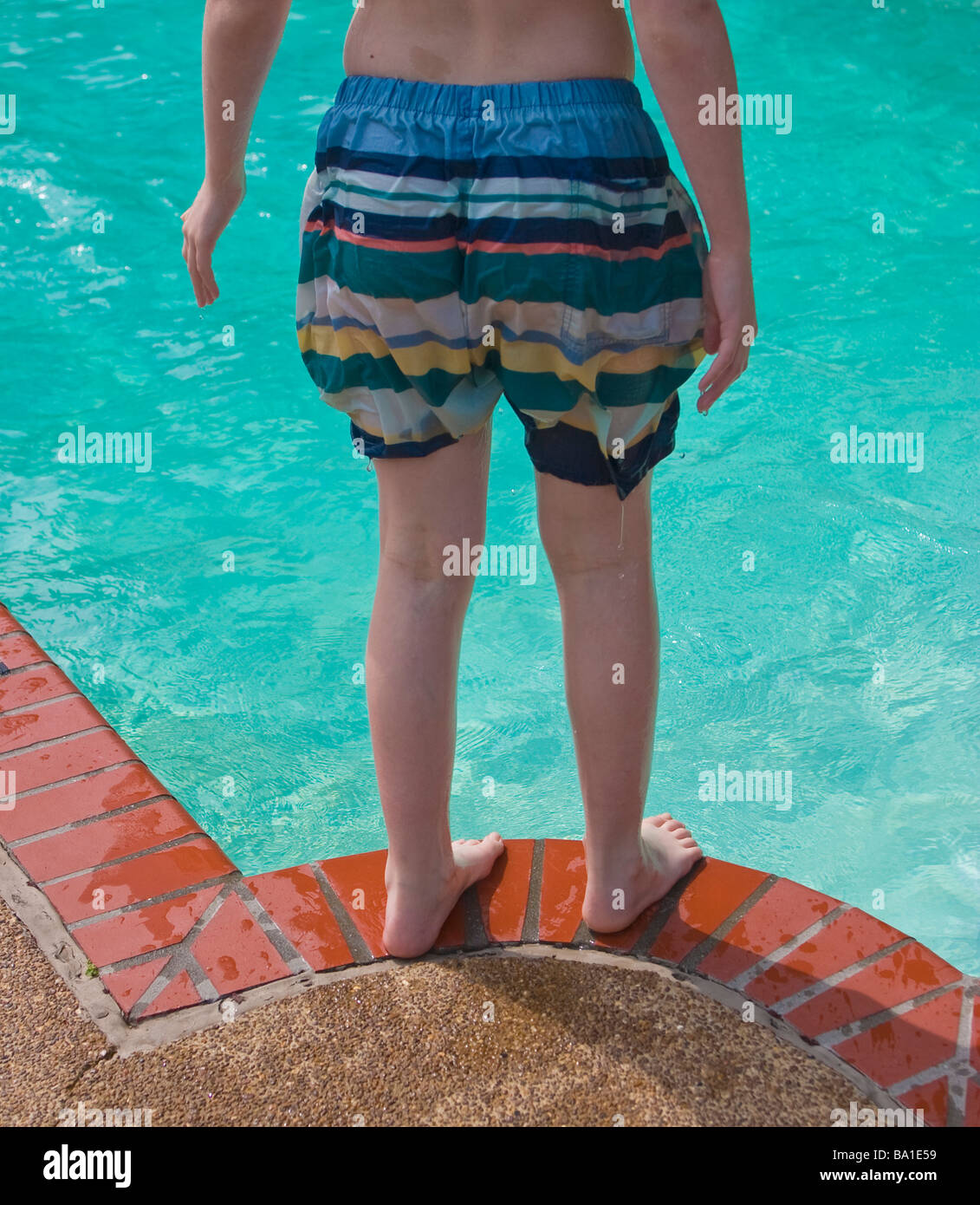Boy on edge swimming pool hi-res stock photography and images - Alamy