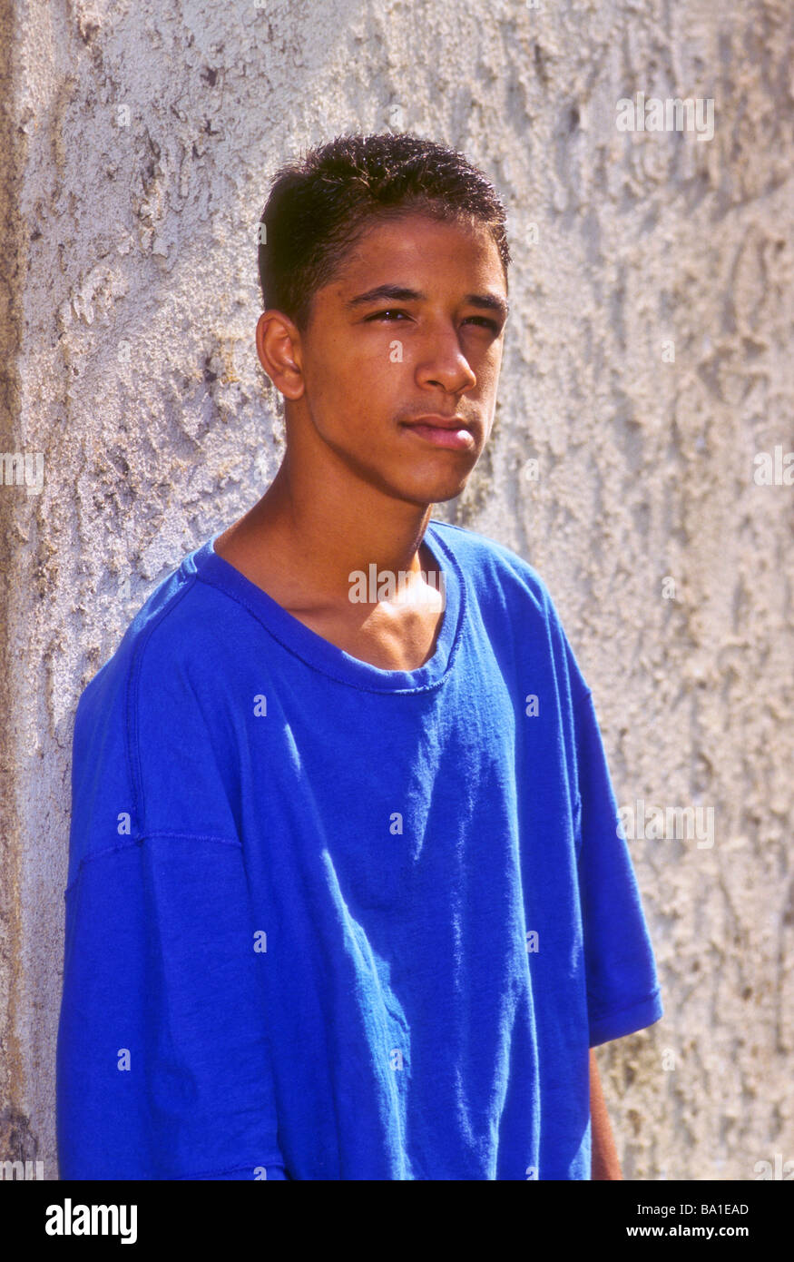 Black teen boy seriious intent direct look stare face sun portrait ...