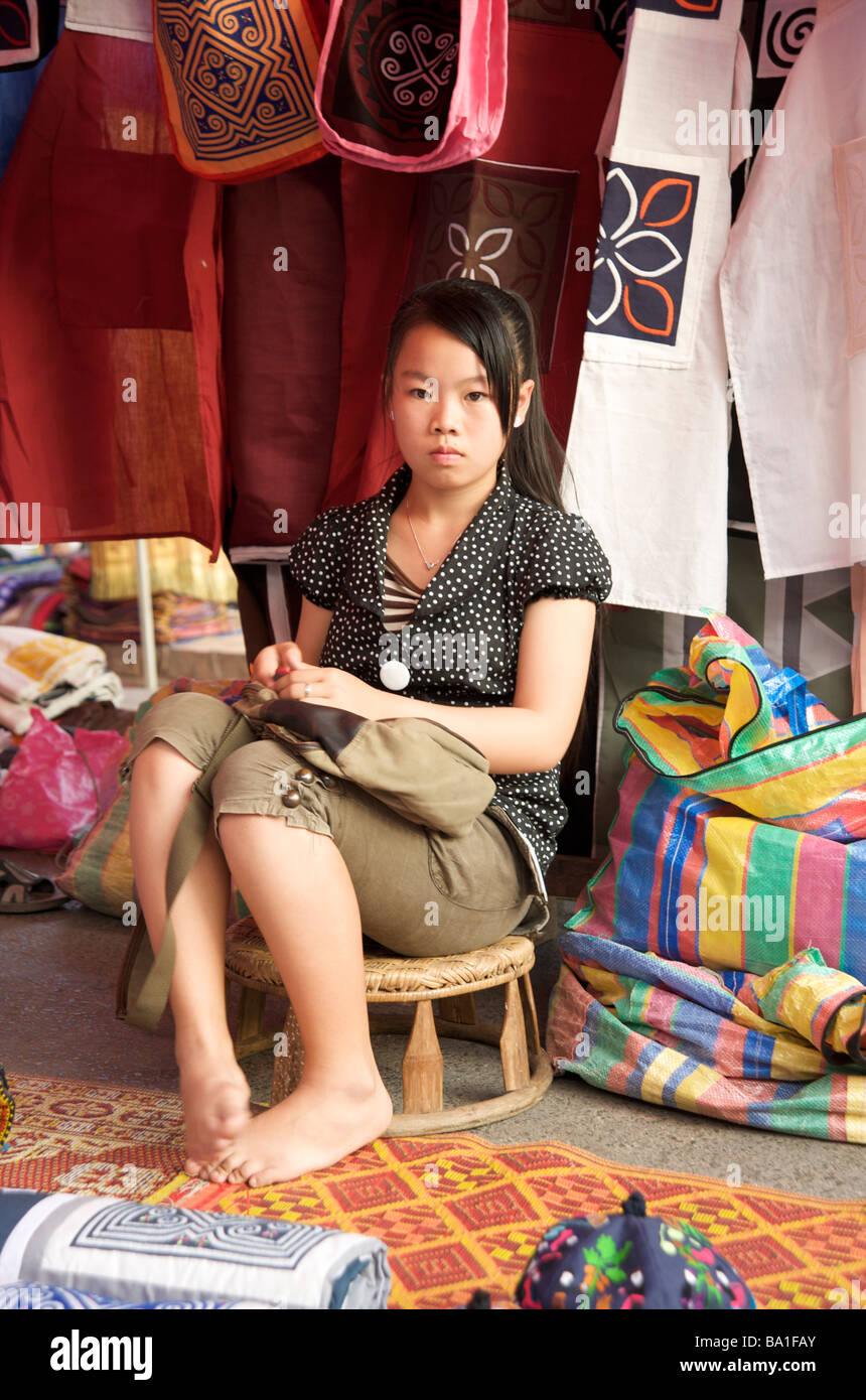 A young Lao girl sits at her souvenir stall in the night market Luang ...