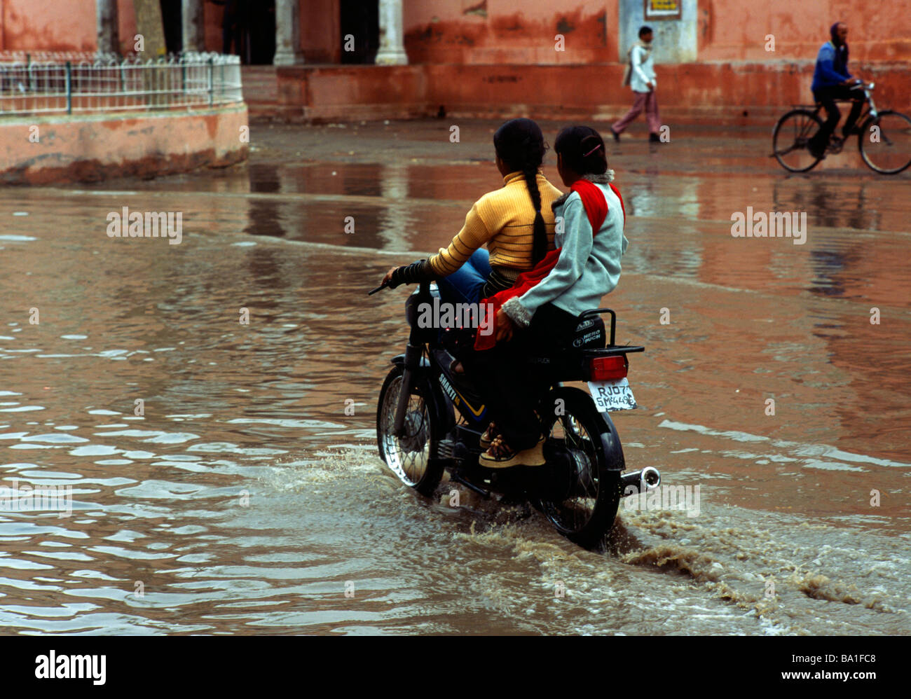Indian women on moped in flood water, India Stock Photo - Alamy
