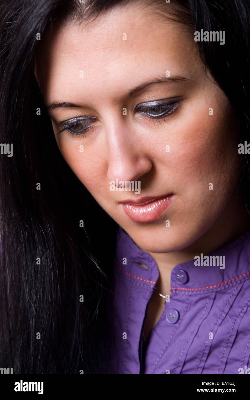 Beautiful young woman looking down Stock Photo - Alamy