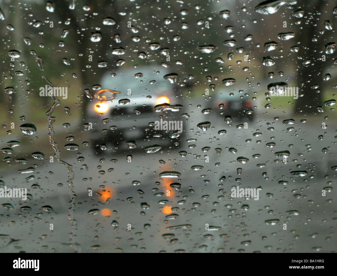 Looking through wet windshield of car Stock Photo - Alamy