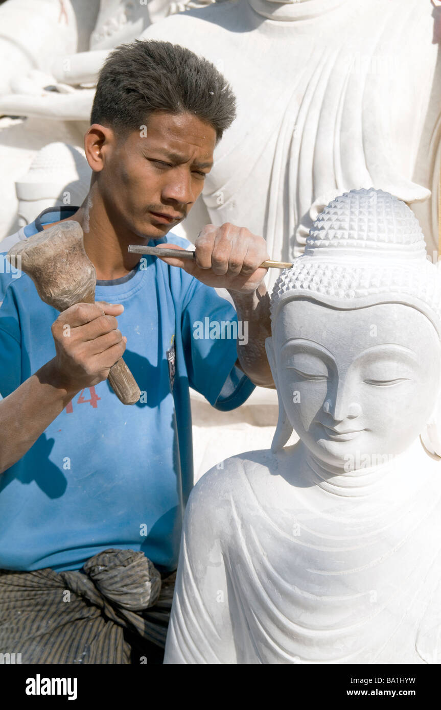 MYANMAR/BURMA. MAN CHISELING BUDDHA STATUES AT A WORKSHOP NEAR MANDALAY ...