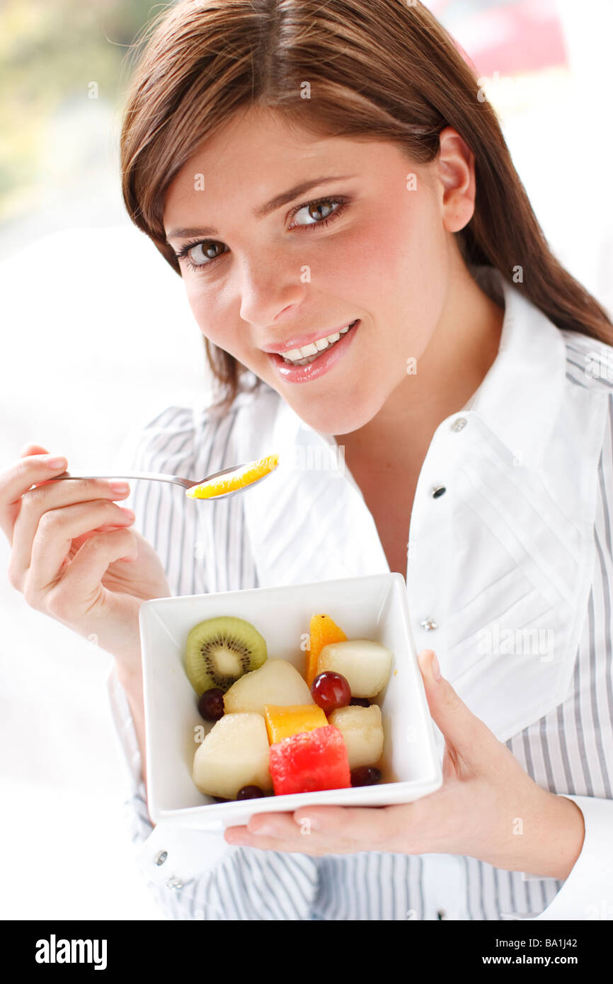 Girl eating fruit salad Stock Photo - Alamy