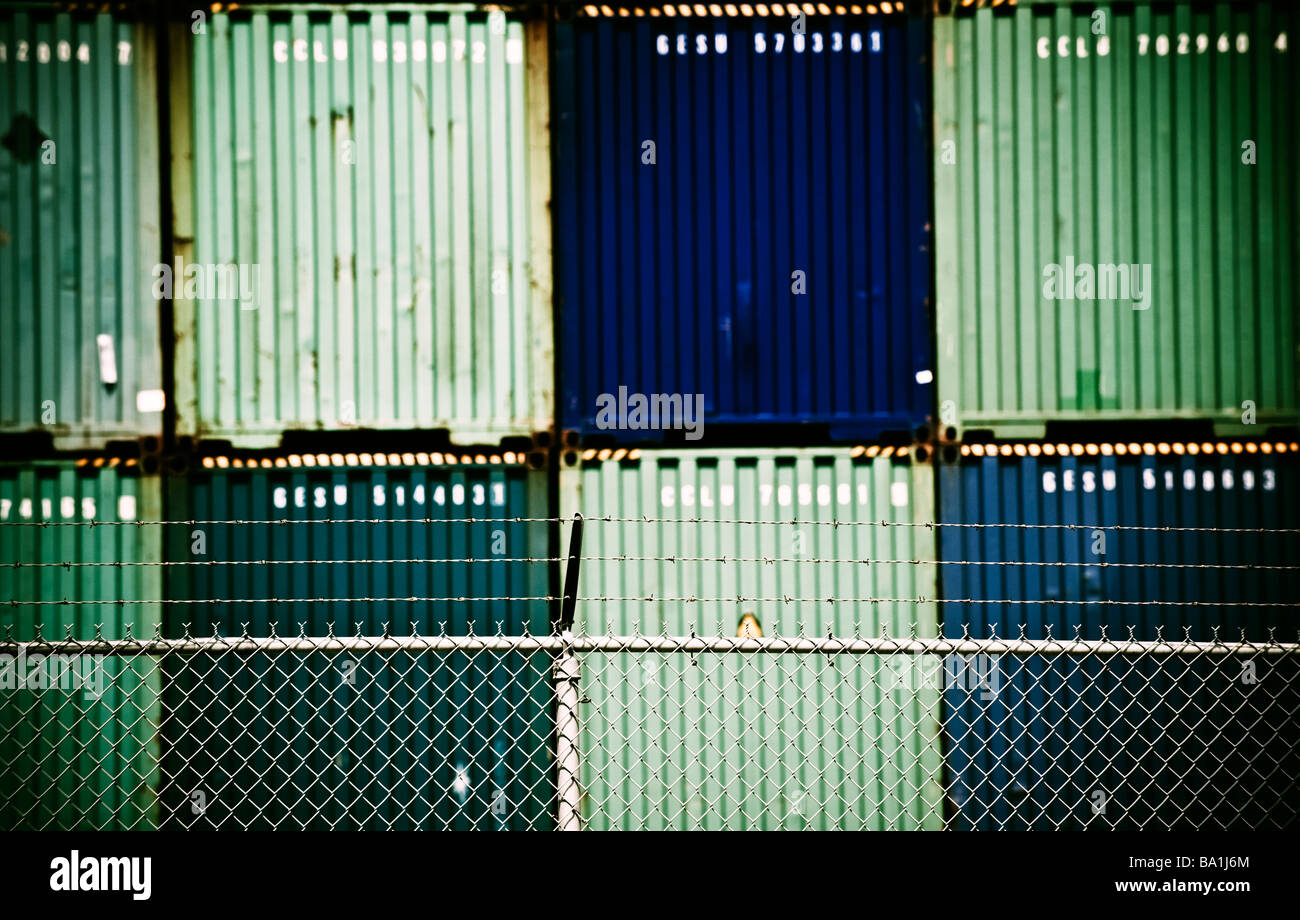 barbwire fence surrounding shipping containers Stock Photo - Alamy