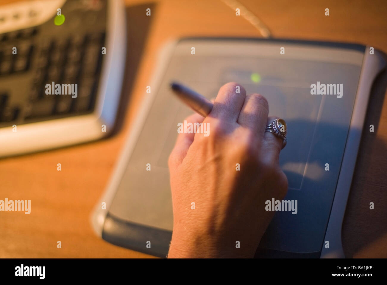 Woman's hand drawing on pen tablet Stock Photo - Alamy