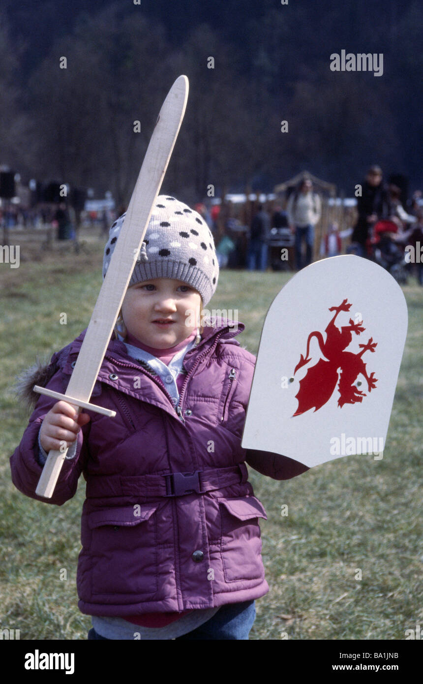 Toddler girl with wooden sword and shield on country fair Stock Photo ...