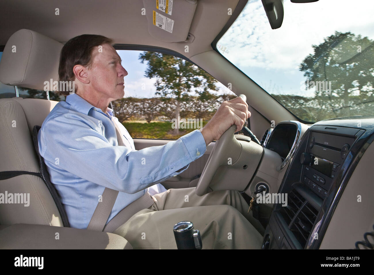 Passenger seat view of older man driving SUV Stock Photo - Alamy