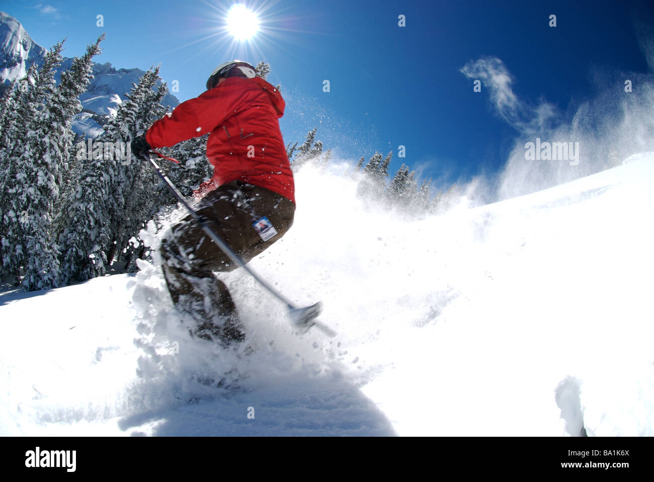 a skiers skis through deep powder on a sunny day in telluride colorado ...